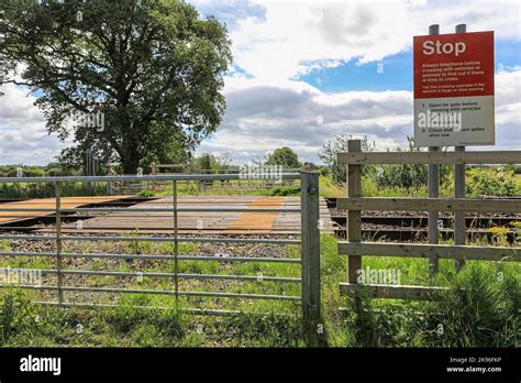 a warning sign on an unmanned railway level crossing with manualy