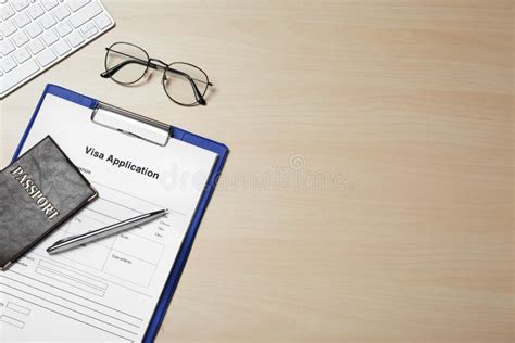 Visa Application Form Passport Glasses And Pen On Wooden Table Flat