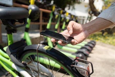 Digital Engagement And Smart Mobility A Person Scanning Their Mobile Device To Access Bike