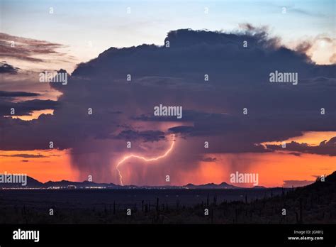 Dramatic Monsoon Thunderstorm Clouds And Lightning Strike At Sunset In