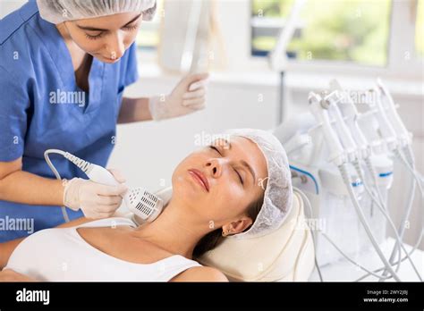 Female Patient Experiencing Cryotherapy Procedure On Neck Using Ice