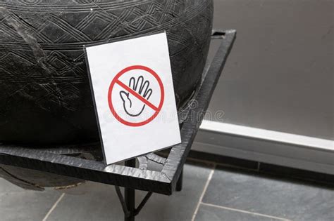a simple do not touch label warning sign with a crossed out hand symbol