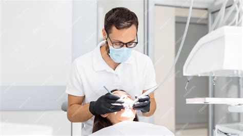 Premium Photo Young Doctor Drilling Teeth To Female Patient