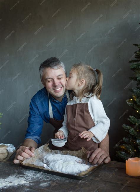 Premium Photo A Little Daughter Kisses Her Dad On The Cheek While