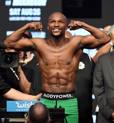 Boxer Floyd Mayweather Jr Poses On The Scale During His Official
