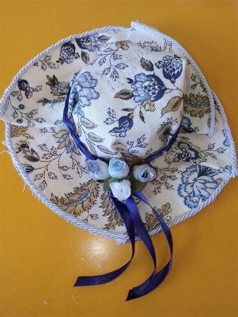 White Hat With Blue Ribbon And Flowers