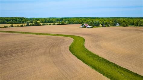 Premium Photo Flat Farmland Terrain With Snaking River Of Green Grass