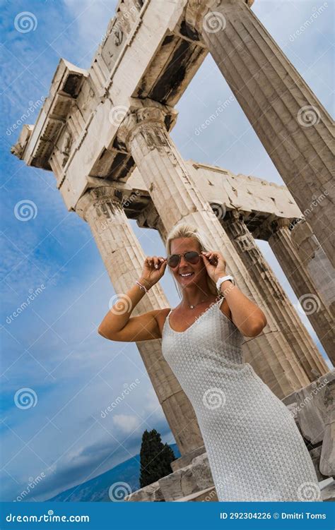 Beautiful Blonde Tourist Girl Near The Parthenon In Greece A Photo With A Littered Horizon