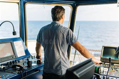 Marine Navigational Officer During Navigational Watch On Bridge Stock