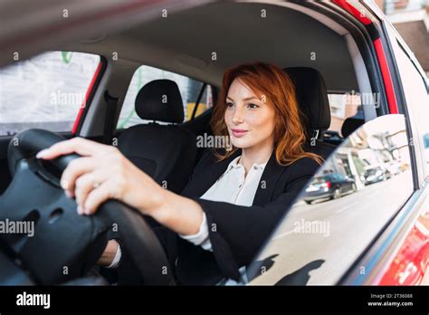 Smiling Redhead Businesswoman Driving Car Stock Photo Alamy