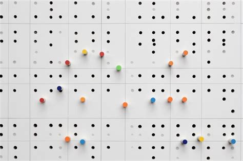 premium ai image simetrical rows and columns of holes on a white pegboard
