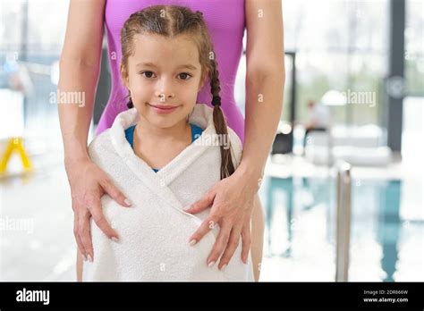 Hands Of Young Female In Lilac Swimsuit Embracing Her Wet Little