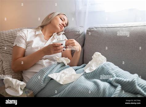 Sick Woman Sitting Under The Blanket Sick Woman With Seasonal Infections Flu Allergy Lying In