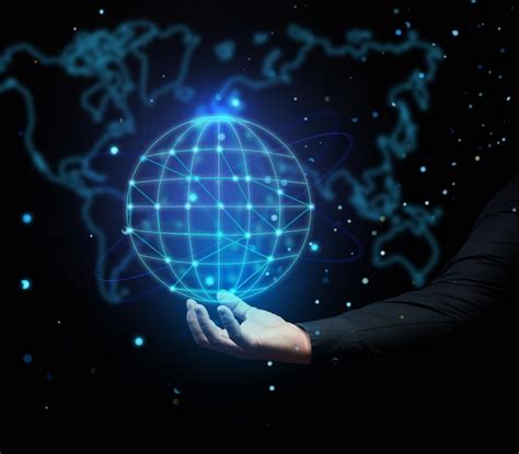 Premium Photo A Mans Hand Holds A Holographic Globe On A Dark Blue