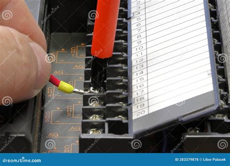 An Electrical Engineer Connects A Wire To A PLC Terminal Block Stock Photo Image Of