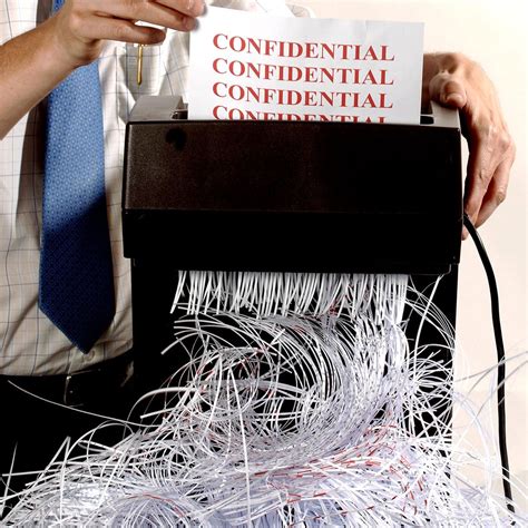 Person Shredding Paper