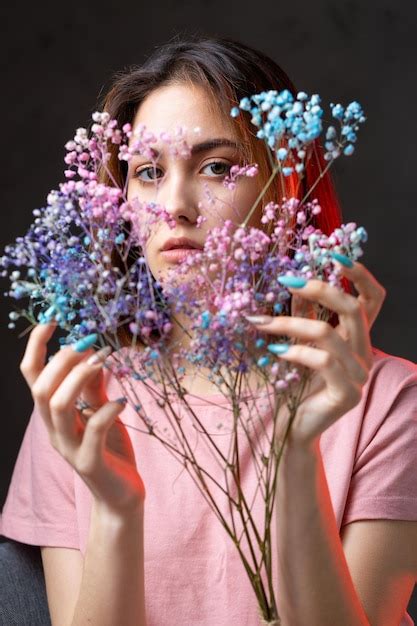 Menina Vestida De Pijama Rosa Segurando Um Buquê De Flores Secas Foto