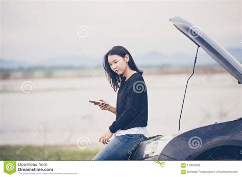 Asian Woman Using Mobile Phone While Looking And Stressed Man Si Stock