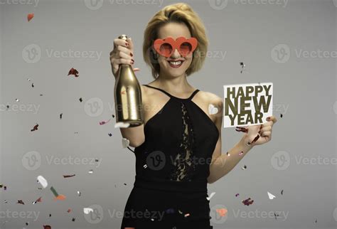 Attractive Blonde Women Celebrating New Year Holding Sign Happy New