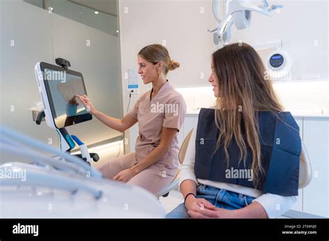 Dentist Using Modern Technology To Explain A Dental Procedure To A