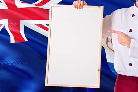 앵귈라 국기 배경에 빈 화이트 보드 메뉴를 들고 안 시 언 요리사 텍스트에 대 한 균일 한 포인팅 공간을 착용 요리 고급 요리에 대한 스톡 사진 및 기타 이미지 Istock