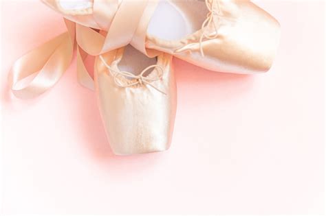 분홍색 배경에 고립 된 새틴 리본이있는 새로운 파스텔 베이지 색 발레 신발 댄스 트레이닝을 위한 발레리나 클래식 포인테 슈즈