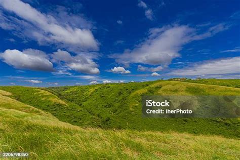 Beautiful Landscape Of Green Hills With Clouds And Blue Sky Panoramic