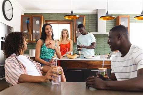 Diverse Group Of Friends Enjoy A Casual Gathering In A Modern Kitchen