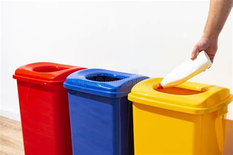A Man Throws Garbage Into The Trash Can Close Up Photo Stock Photo Image Of Recycle Hand