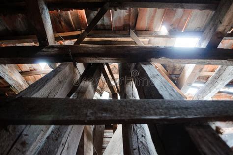A Glimpse Into Forgotten Architecture The Intricate Wooden Framework Of An Abandoned Structure