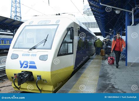Group Of Passengers Standing In Front Of Doors Of The Passenger Train