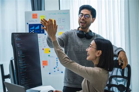 Asian And Indian Developer Team Clapping Hand For Project Success With Software Computer At