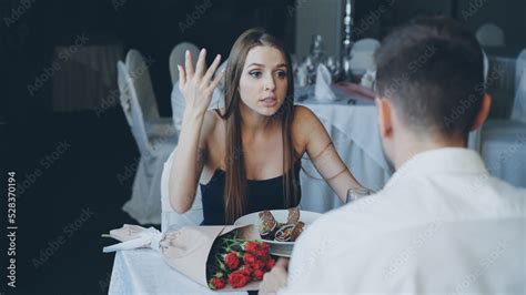 Angry Babe Woman Is Quarreling With Her Lover While Dining In Restaurant Shouting And