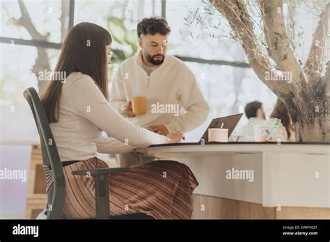 Diverse Colleagues Collaborating In Office Discussing Project Details