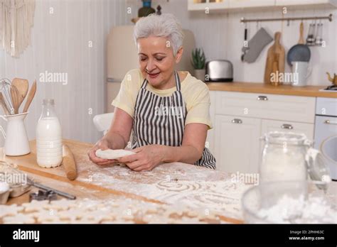Happy Senior Woman Cooking In Kitchen Stylish Older Mature Gray Haired
