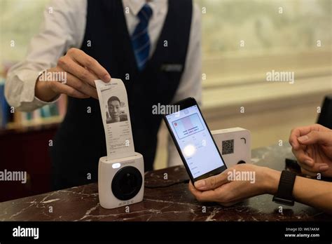 a chinese mobile phone user uses his electronic identification card in