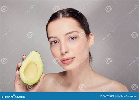 Pensive Nude Lady With Perfect Pure Shine Skin With Avocado In Hand