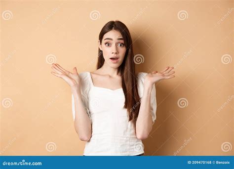 Surprised Caucasian Girl Look With Disbelief And Amazement Spread Hands Sideways And Gasping