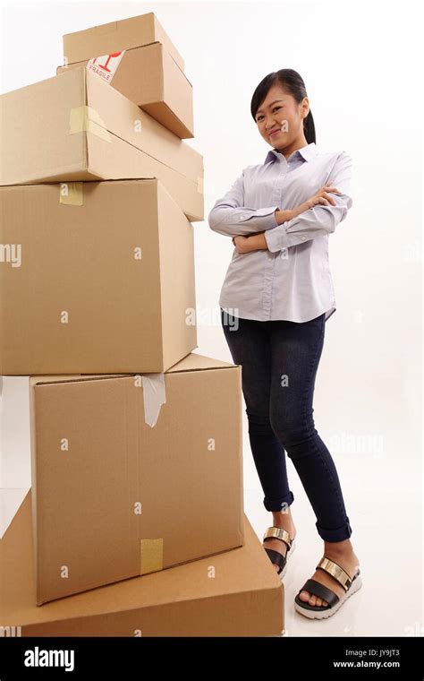 Asian Woman With Stack Of Boxes On The White Background Stock Photo Alamy