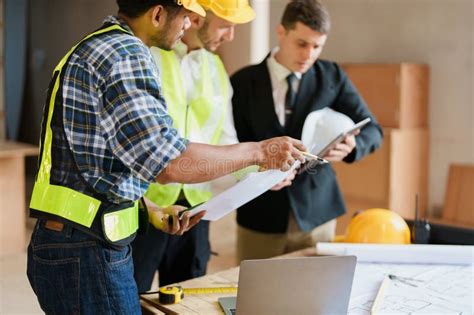 Multi Ethnic Engineer Brainstorming And Measuring For Cost Estimating