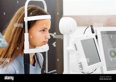 Teenage Girl Udergoing Eye Survey On Modern Diagnostics Device In
