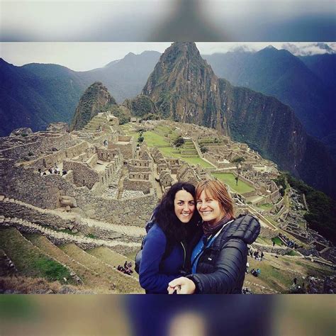 Two Women Taking A Selfie In Front Of The Ruins Of Machu Picach