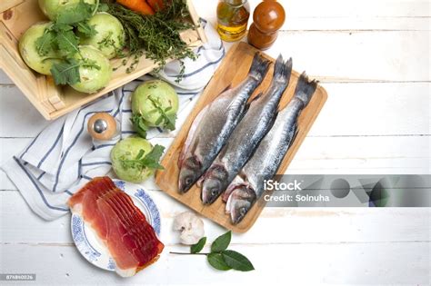 원시 바다 농 어 알 줄기 양배추 당근 백 리 향 마늘 베이컨 베이 잎과 하얀 테이블에 올리브 오일 0명에 대한 스톡 사진 및 기타 이미지 Istock