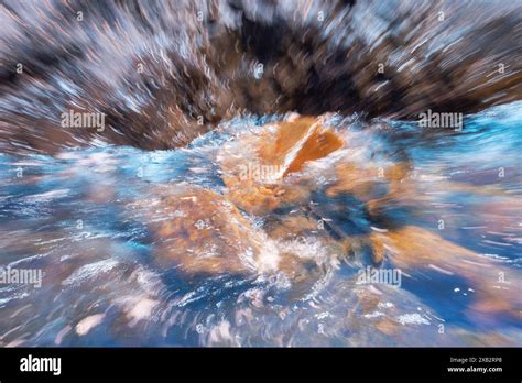 A Dynamic Image Showing Abstract Swirling Colors Blending Seamlessly Within A Body Of Seawater