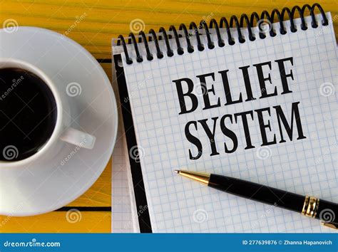 Belief System Words On A White Sheet On A Yellow Wooden Background