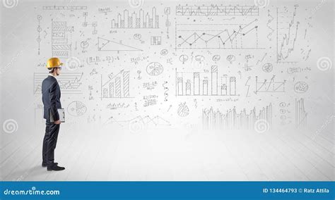 Engineer Holding A Plan And Standing With Graphs Charts And Reports On