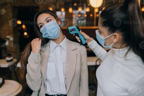 Woman Measuring Body Temperature With Contactless Body Thermometer 11754276 Stock Photo At Vecteezy