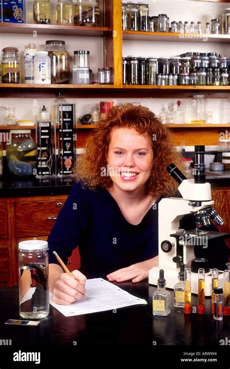 Babe Girl In Th Grade In High Babe Science Class Experiments With Microscope In Babe