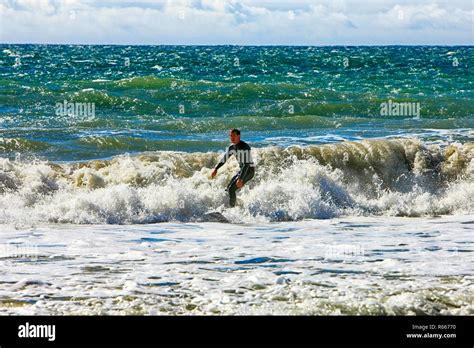 Man Surfboarding In The Pacific Ocean At Hendrys Beach Nr Santa