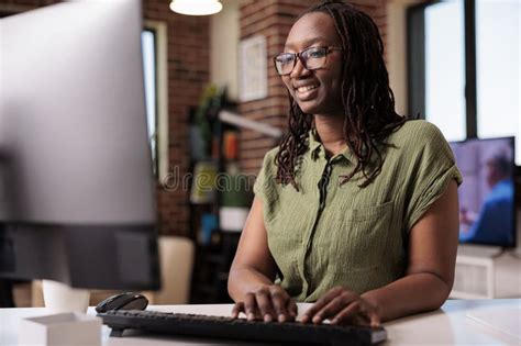 Smiling African American Programmer Relaxing Looking At Funny Content On Computer Screen Stock